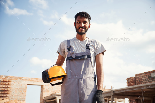 Cheerful and handsome Indian man is on the construction site Stock ...
