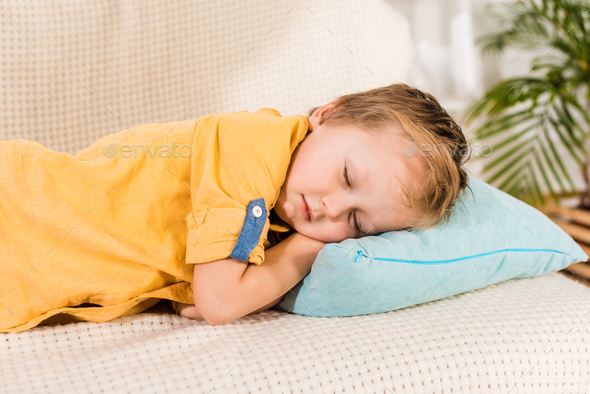 portrait of adorable little boy sleeping on sofa at home Stock Photo by ...