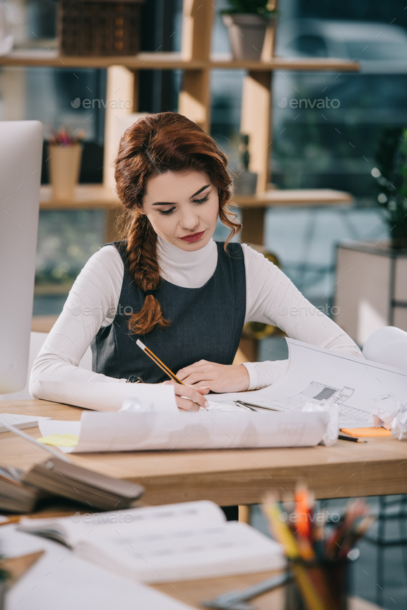 female architect drawing blueprints with pencil and compasses Stock ...