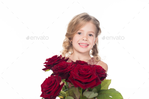 smiling kid in dress holding bouquet of red roses, isolated on white ...