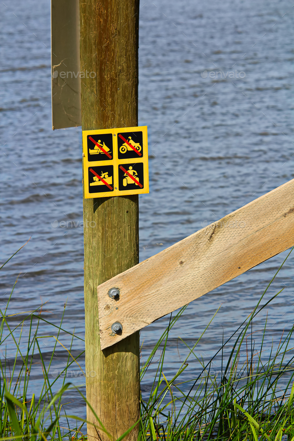 No off-road vehicle sign posted near water Stock Photo by wirestock