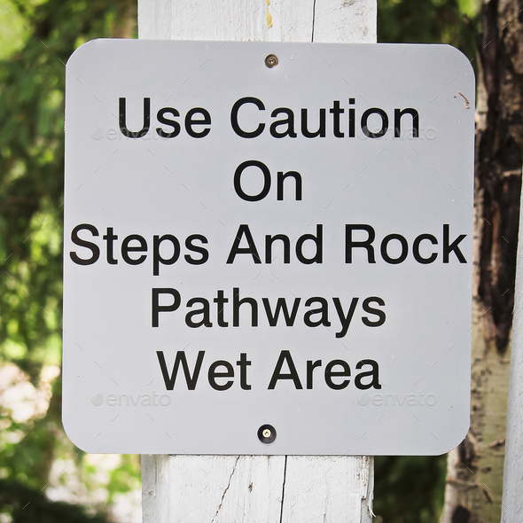 A use caution on steps and rock pathways sign Stock Photo by wirestock