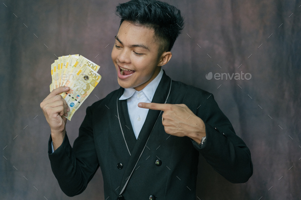 Successful Businessman Happily Holding a lot of Philippine Money ...