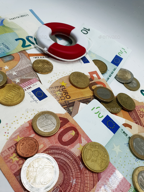 Conceptual shot of lifebuoy with euro banknotes on a white background ...