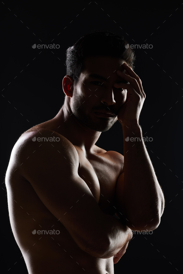 Portrait, body and muscle of man in studio isolated on black background ...