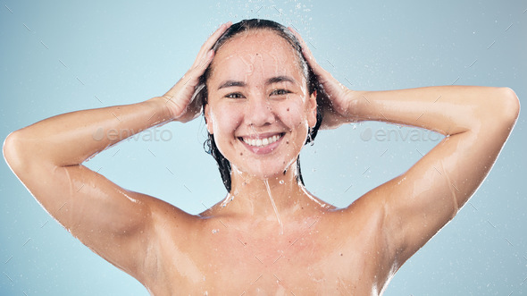 Face, shower and woman smile washing hair in studio isolated on blue ...