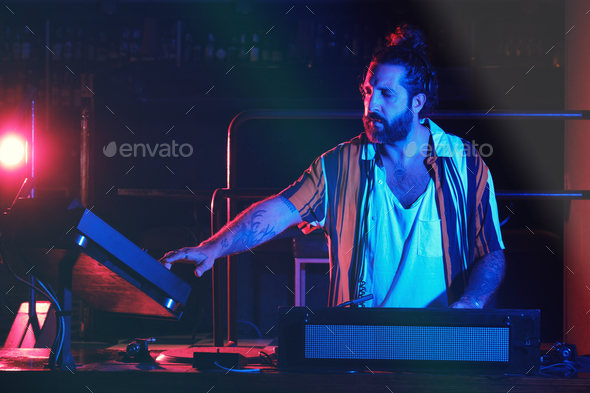 DJ playing music in nightclub Stock Photo by ADDICTIVE_STOCK | PhotoDune