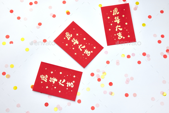 Overhead shot of red postcards with Chinese gold letters and colorful ...