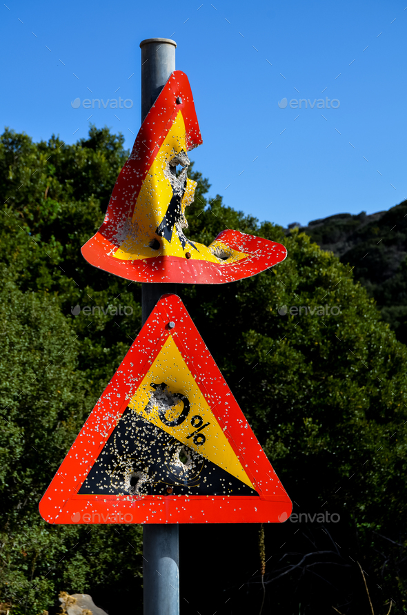 Vertical shot of damaged road signs near trees in Crete, Greece Stock ...