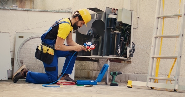 Electrician doing hvac system checkup Stock Photo by DC_Studio | PhotoDune