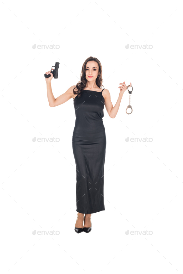 beautiful female secret agent in black dress holding gun and handcuffs ...