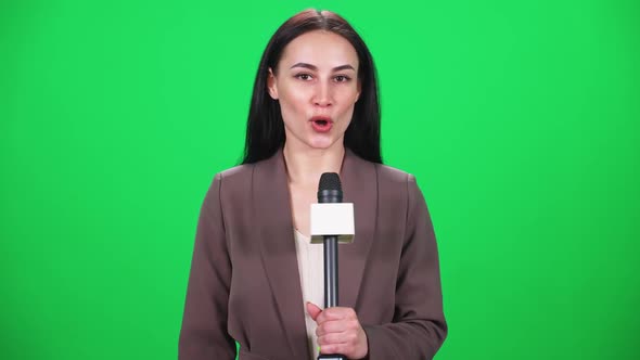 Woman News Reporter in Suit Looks Into the Camera and Speaks Into a ...