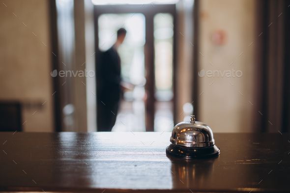 Arrival at the hotel. Reception desk with a bell in the hotel lobby ...
