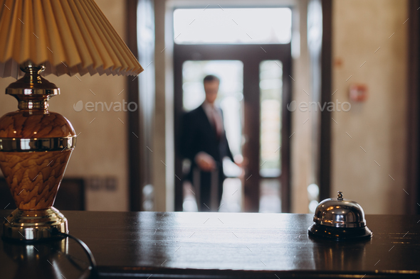 Arrival at the hotel. Reception desk with a bell in the hotel lobby ...