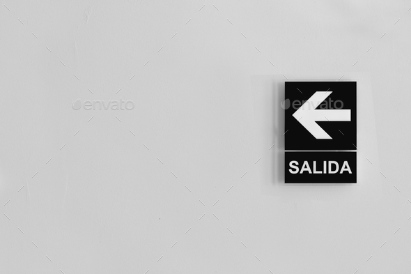 Grayscale exit (SALIDA) sign in Spanish with left arrow Stock Photo by ...