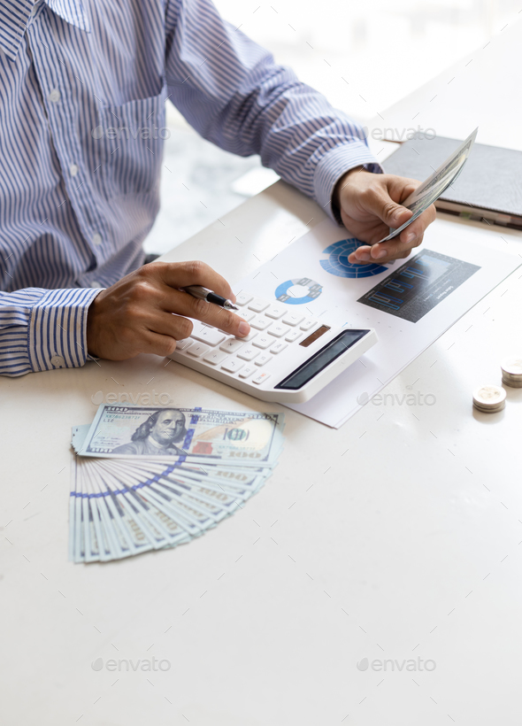 Investment and financial planning. Businessman using calculator ...