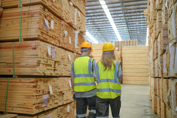 Woman with checklist in a timber and lumber warehouse. Product ...