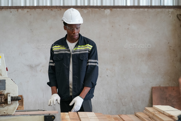 Young black man working at lumber distribution warehouse. Stock Photo ...