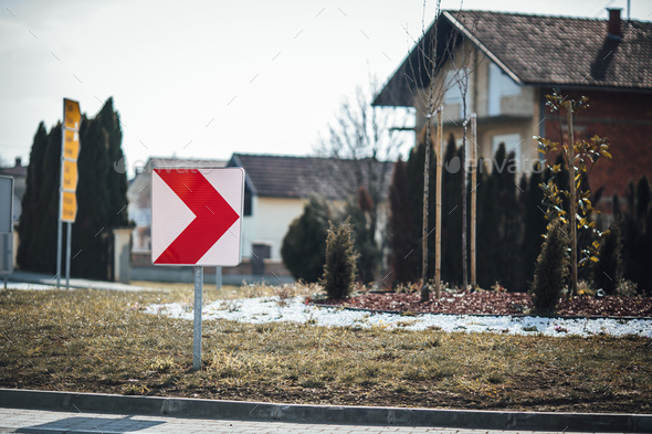 Shot of traffic signs, a triangle marked in red and a circle in blue ...