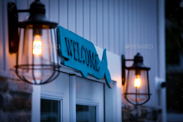 WELCOME sign carved in the shape of a fish is suspended above the door ...