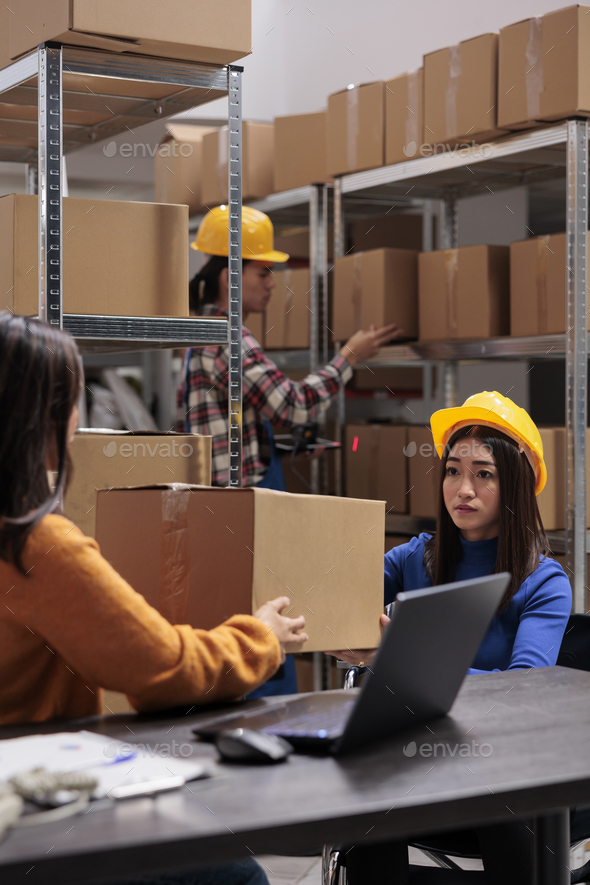 Warehouse manager overseeing product dispatching and parcel sending ...
