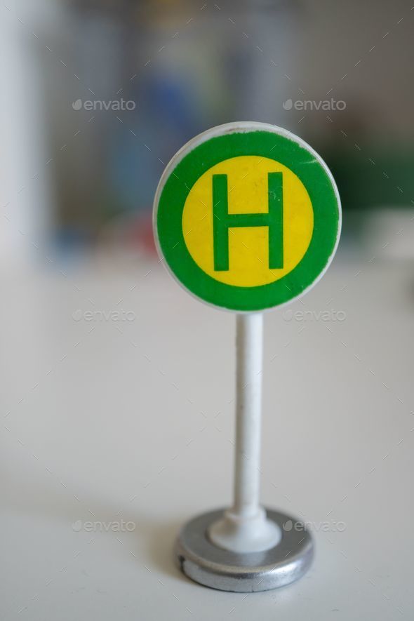 Yellow and green bus stop sign for kids Stock Photo by wirestock ...