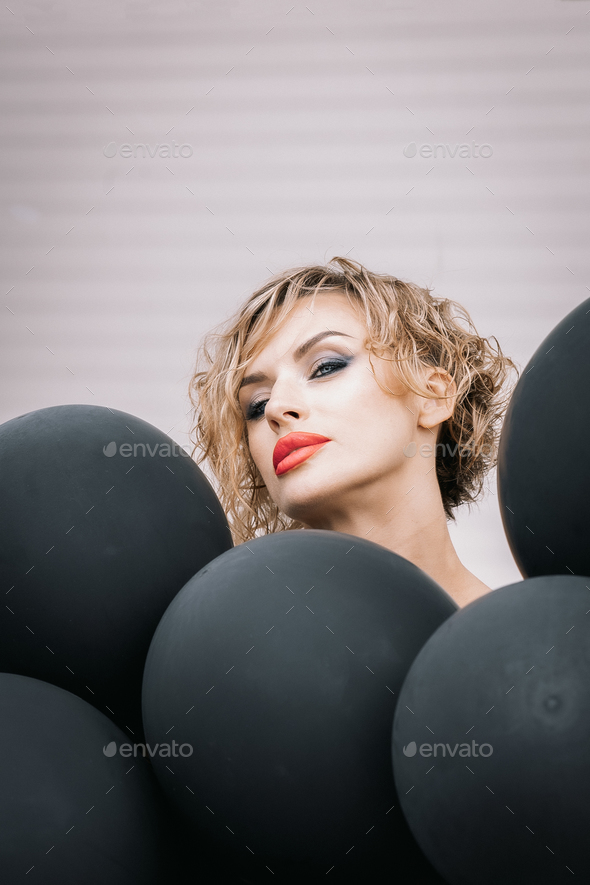 Portrait beautiful woman of model appearance with dark balloons. Art ...