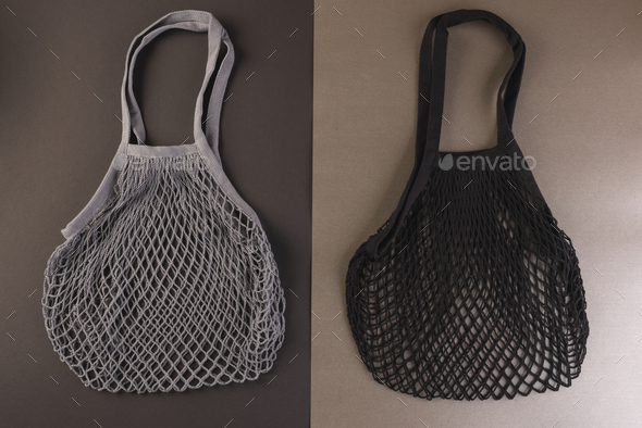 Black and grey mesh net bags with copy space on light and dark brown ...