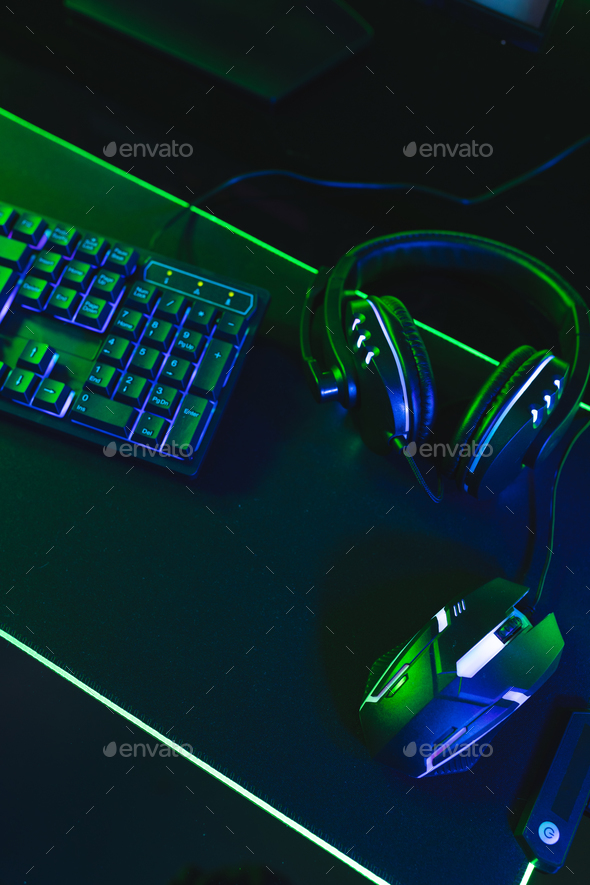 Vertical image of computer, keyboard with video game accessories with ...