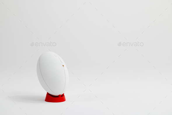 White rugby ball on red stand with copy space on white background Stock ...