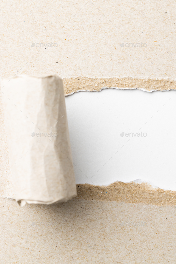 Ripped up piece of beige paper with copy space on white background ...