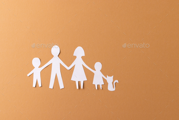 White paper cut out of family with two children and ca and copy space ...