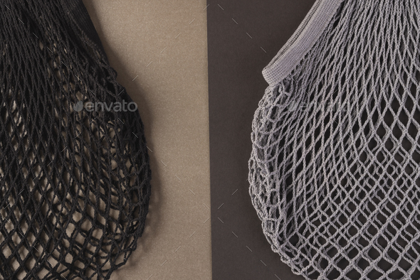 Black and grey mesh net bags with copy space on light and dark brown ...