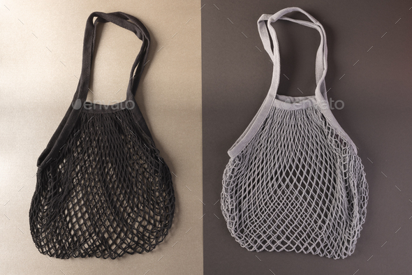 Black and grey mesh net bags with copy space on light and dark brown ...