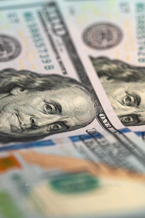 Vertical, close-up shot of a 100 dollar bill with the face of Benjamin ...