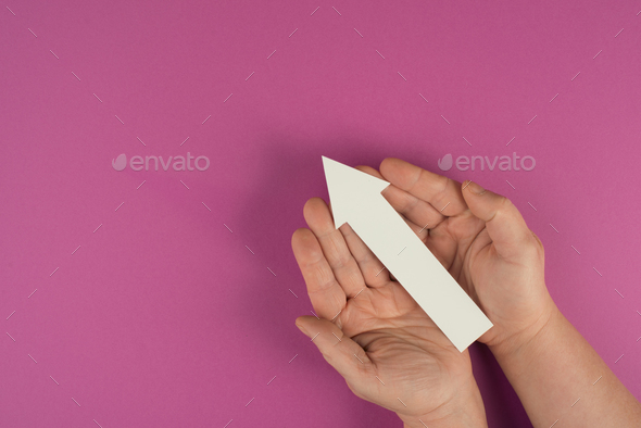 Holding an arrow in the hand, symbol for growth, success and ...