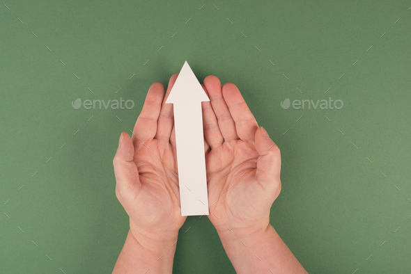 Holding an arrow in the hand, symbol for growth, success and ...