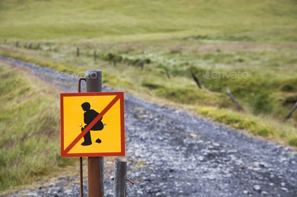 No Pooping sign on a metal post outdoors Stock Photo by wirestock ...