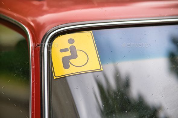 Yellow sign indicating a disabled driver at the car Stock Photo by ...