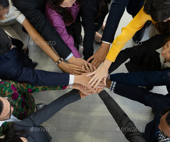 Team, teamwork, and unity concept. Diverse team putting hands together. Group of diverse ...