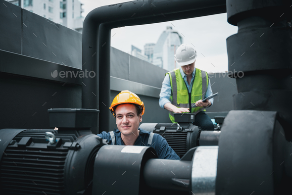 Engineer and team examining the air conditioning cooling system of huge ...