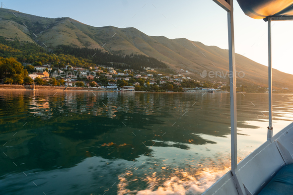 View of the city of Shiroka from the lake at sunset on a traditional ...