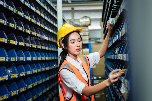 Warehouse worker check the equipment parts on the shelf in the ...