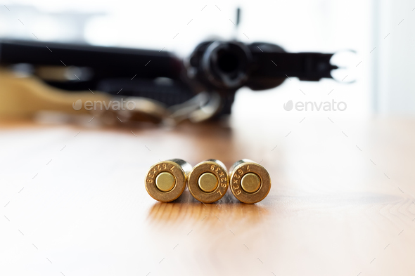 Three bullets bottom against blurred Kalashnikov assault rifle ...