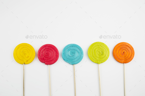 Colorful lollipops and different colored round candy. Top view. Stock ...