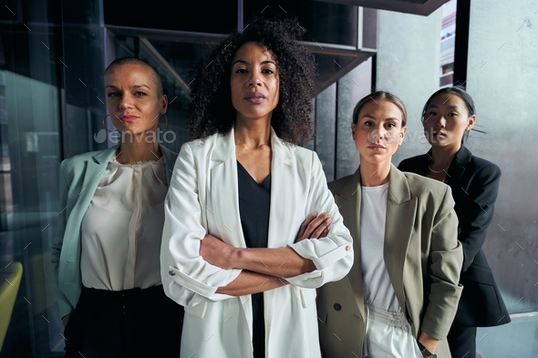 Team portrait diverse female professionals confident posing outside ...