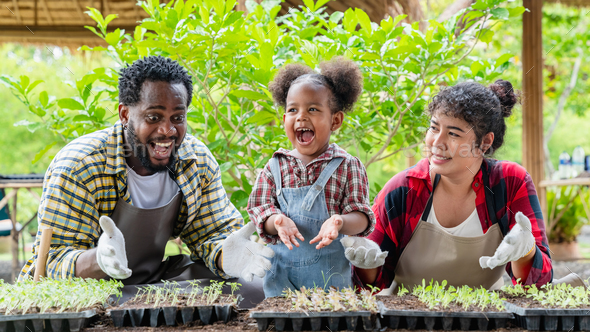 A happy family is planting seedlings in the mini pot., It is another ...