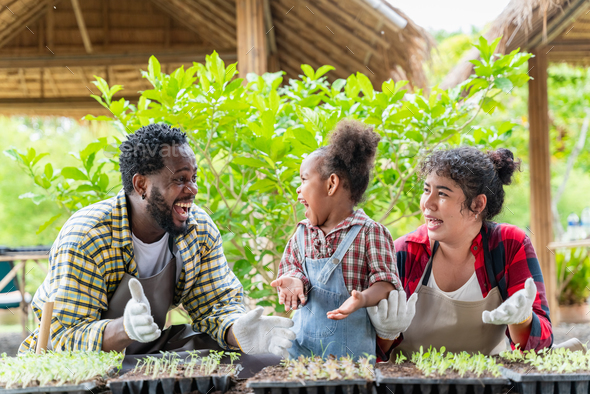 A happy family is planting seedlings in the mini pot., It is another ...