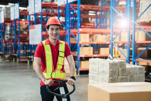 Portrait of warehouse worker smiling and happy in the warehouse ...