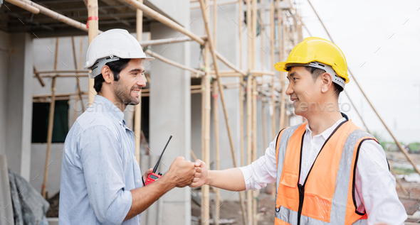 The engineer manager and foreman construction workers shake hands on ...